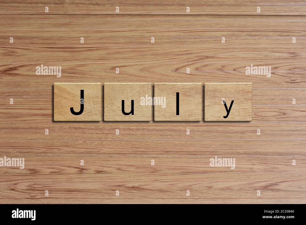 July word written on wood block. Message text on wooden table for ...
