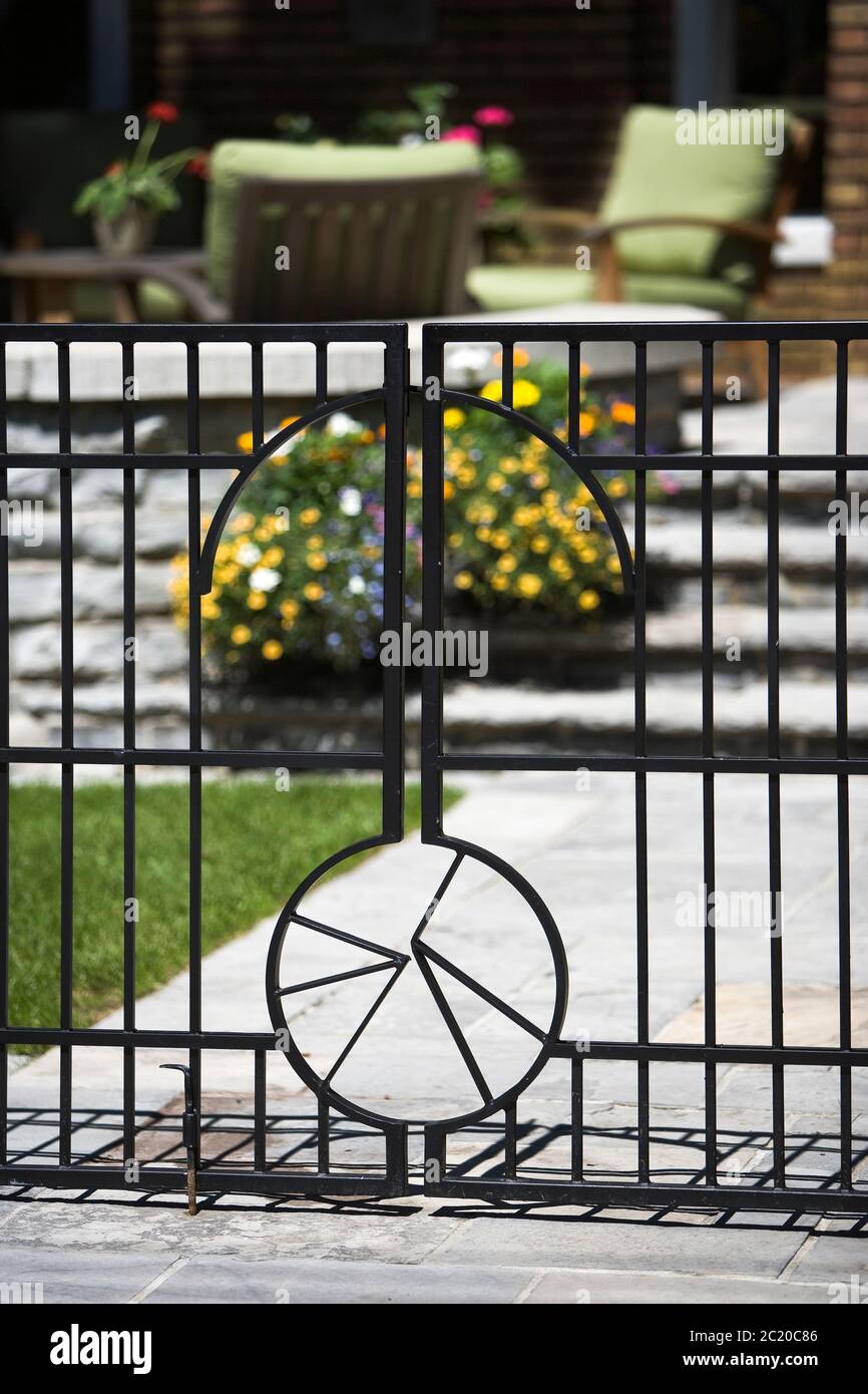 Black steel gate leading to a residential yard Stock Photo - Alamy
