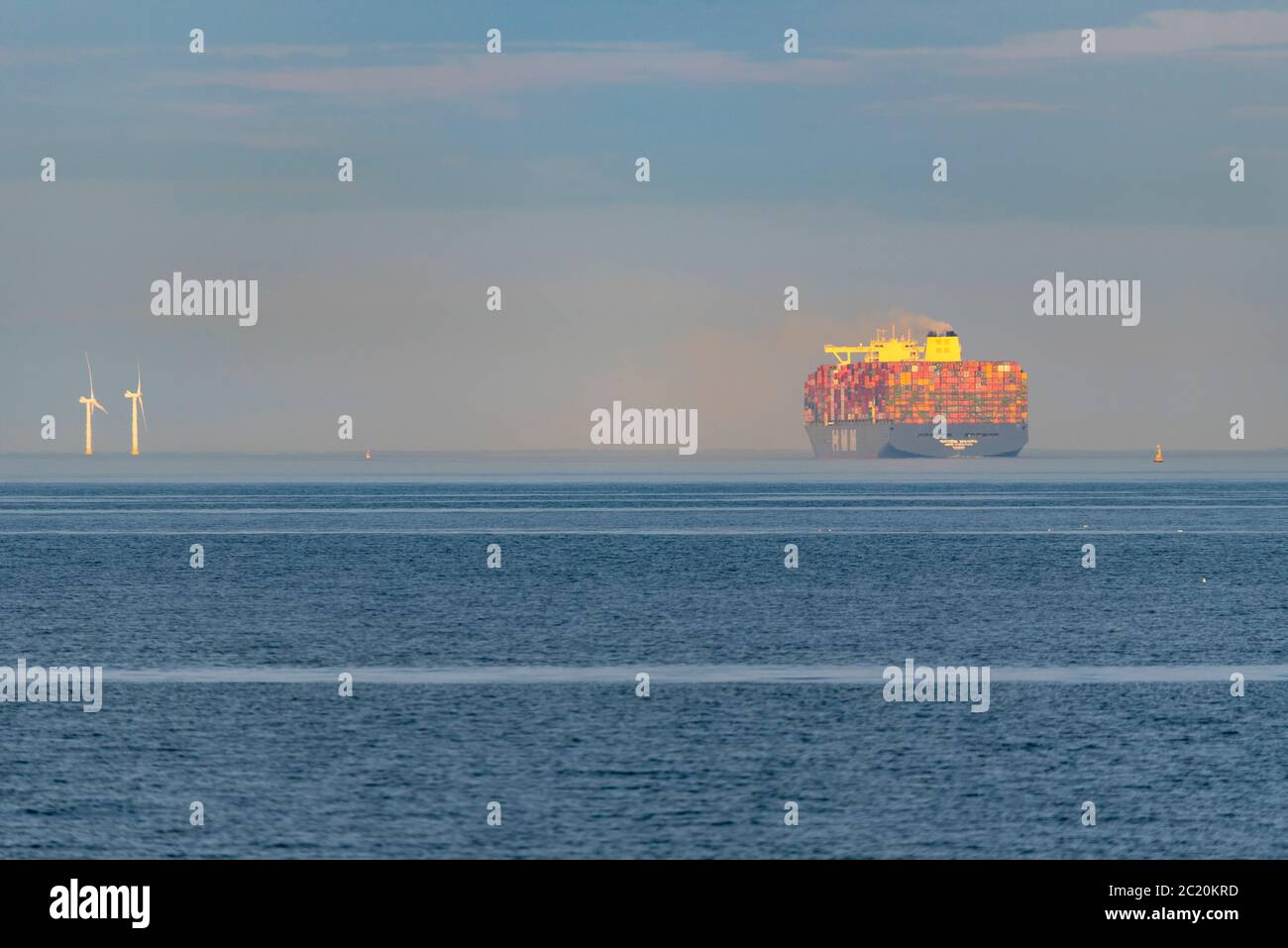 HMM Algeciras container ship with wind farm turbines on the Thames ...