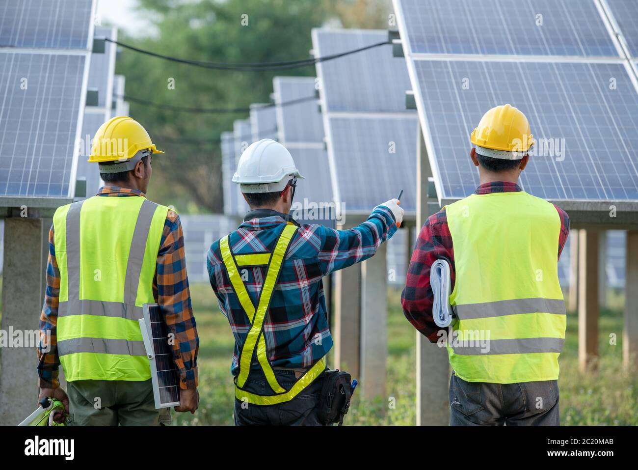 Engineering team inspecting and repairing solar cells on solar farms ...