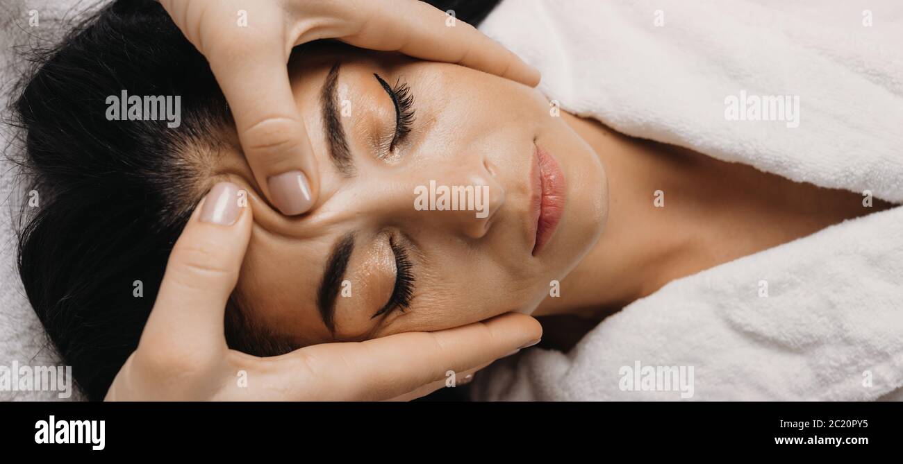 Forehead Massage Session With A Caucasian Woman Lying In A Spa Center