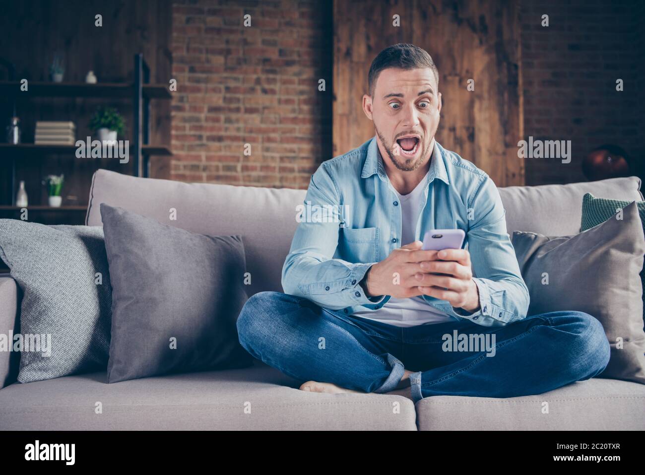 Photo of domestic handsome guy stay home quarantine time hold telephone ...
