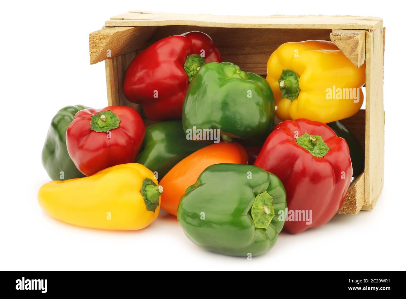 colorful mix of paprika's(capsicum) in a wooden box on a white ...