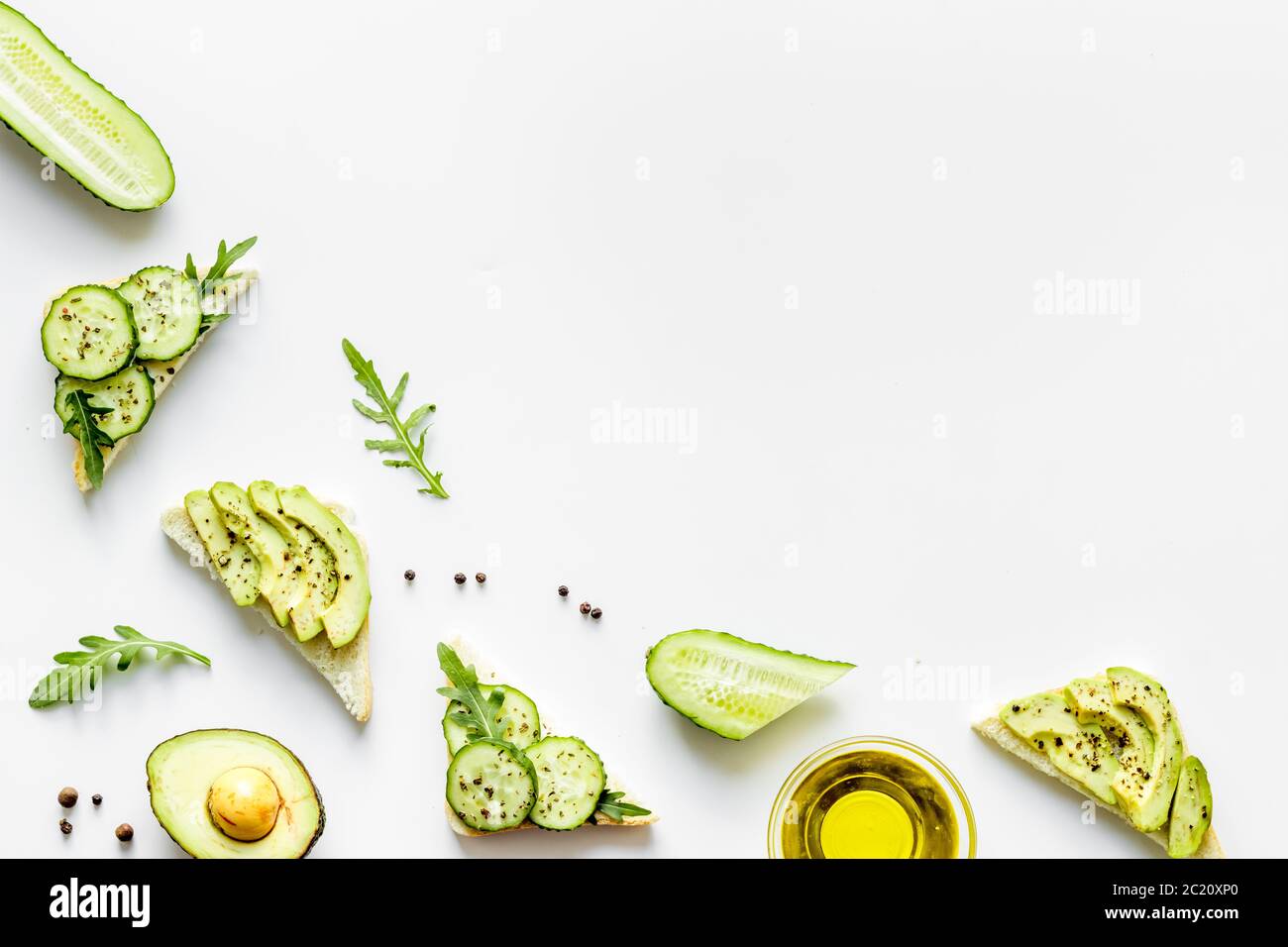 green toasts with avocado on white background from above copy space ...