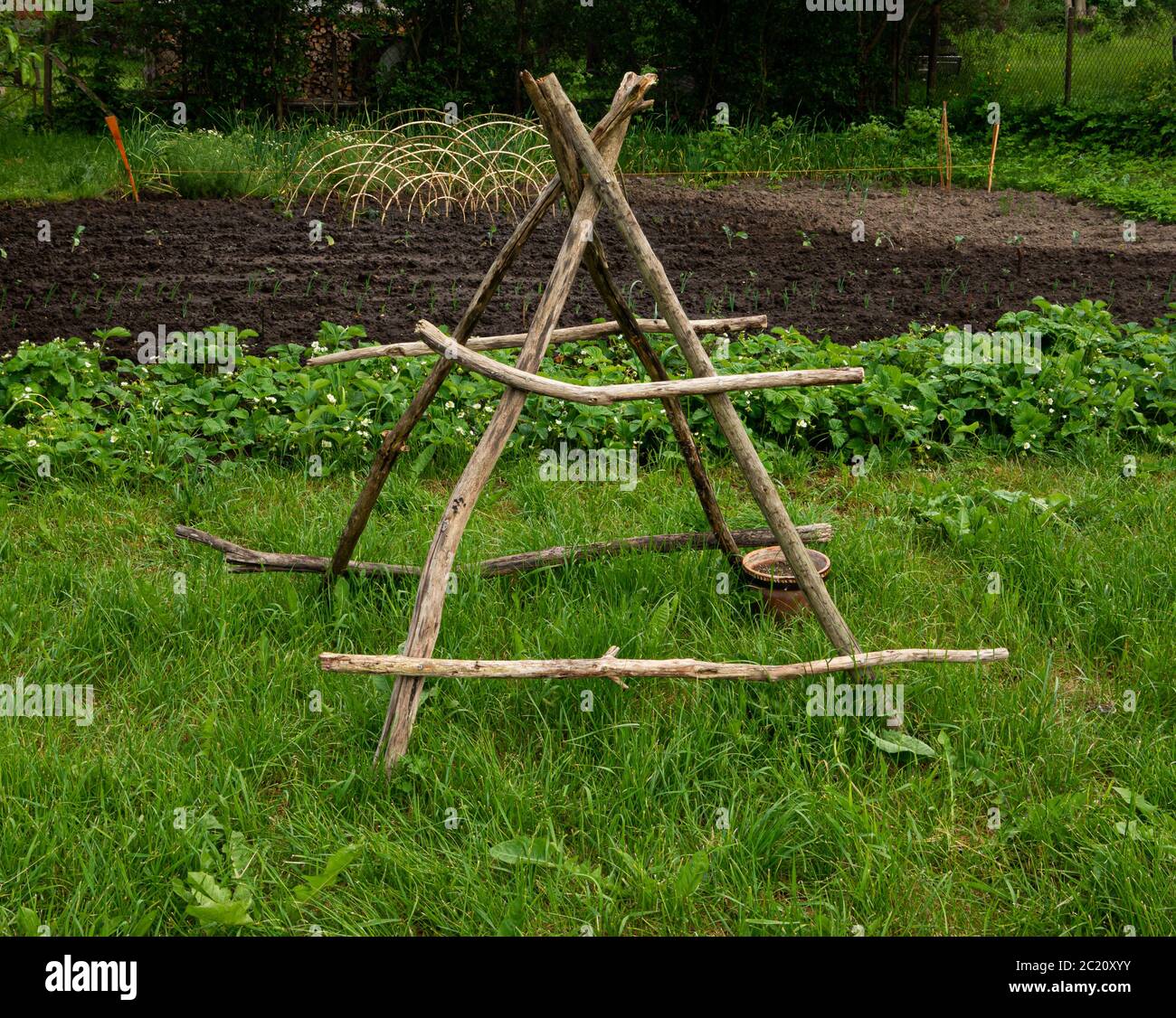 Garden grass stand for grass drying for cows, green Stock Photo - Alamy