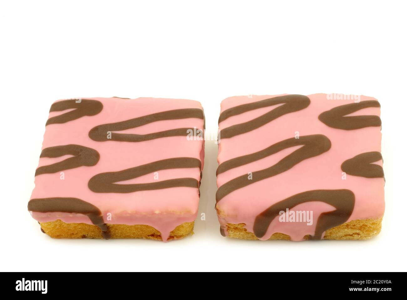 freshly baked square pink glazed cakes with chocolate dressing on a ...