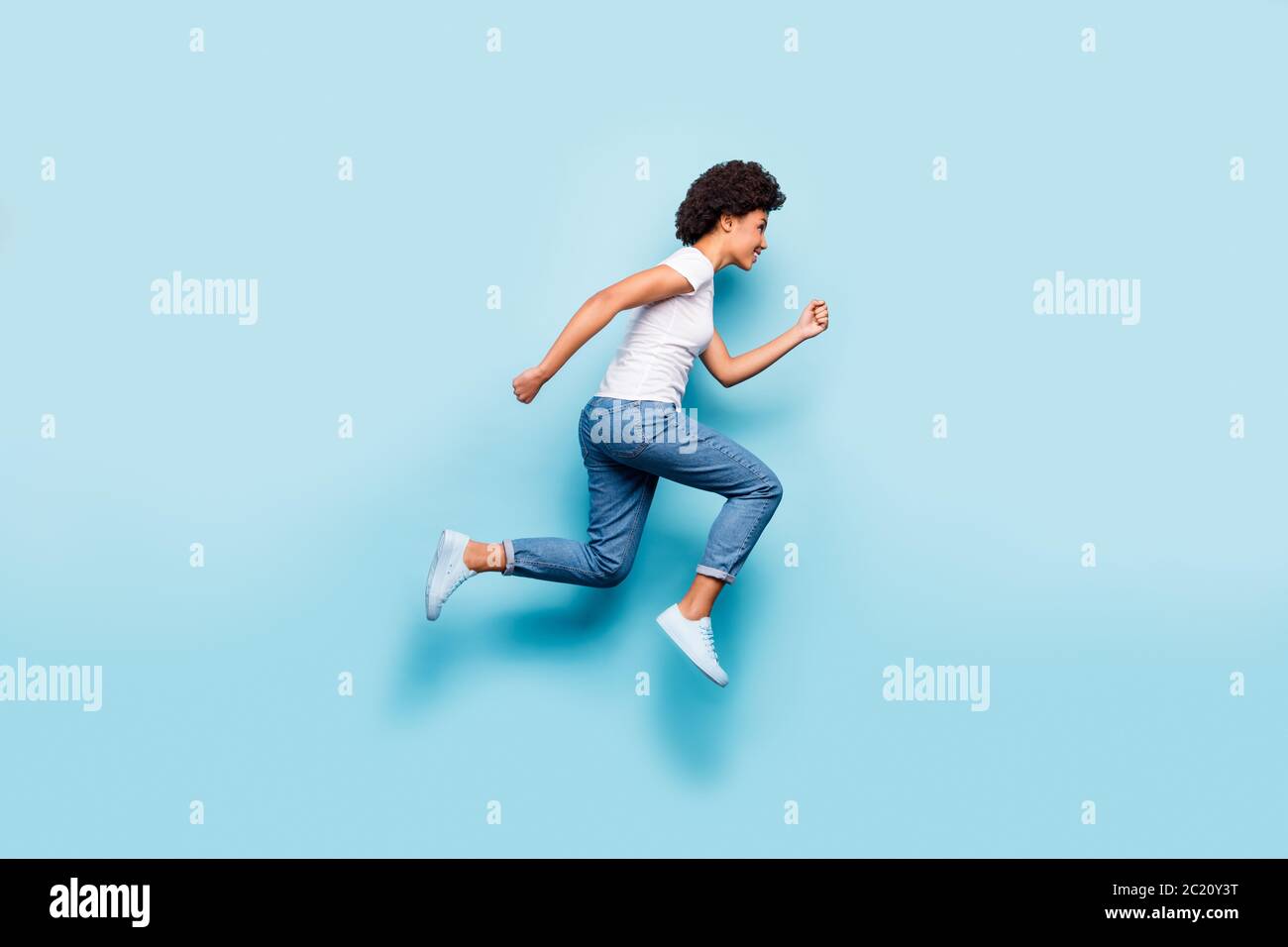 Full size photo of beautiful dark skin curly lady jumping high rushing ...