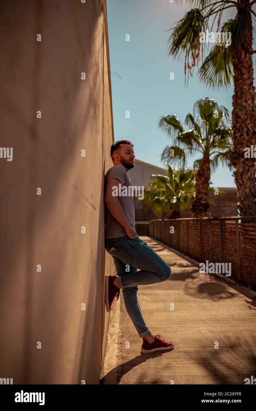 Man portrait leaning on a wall Stock Photo - Alamy