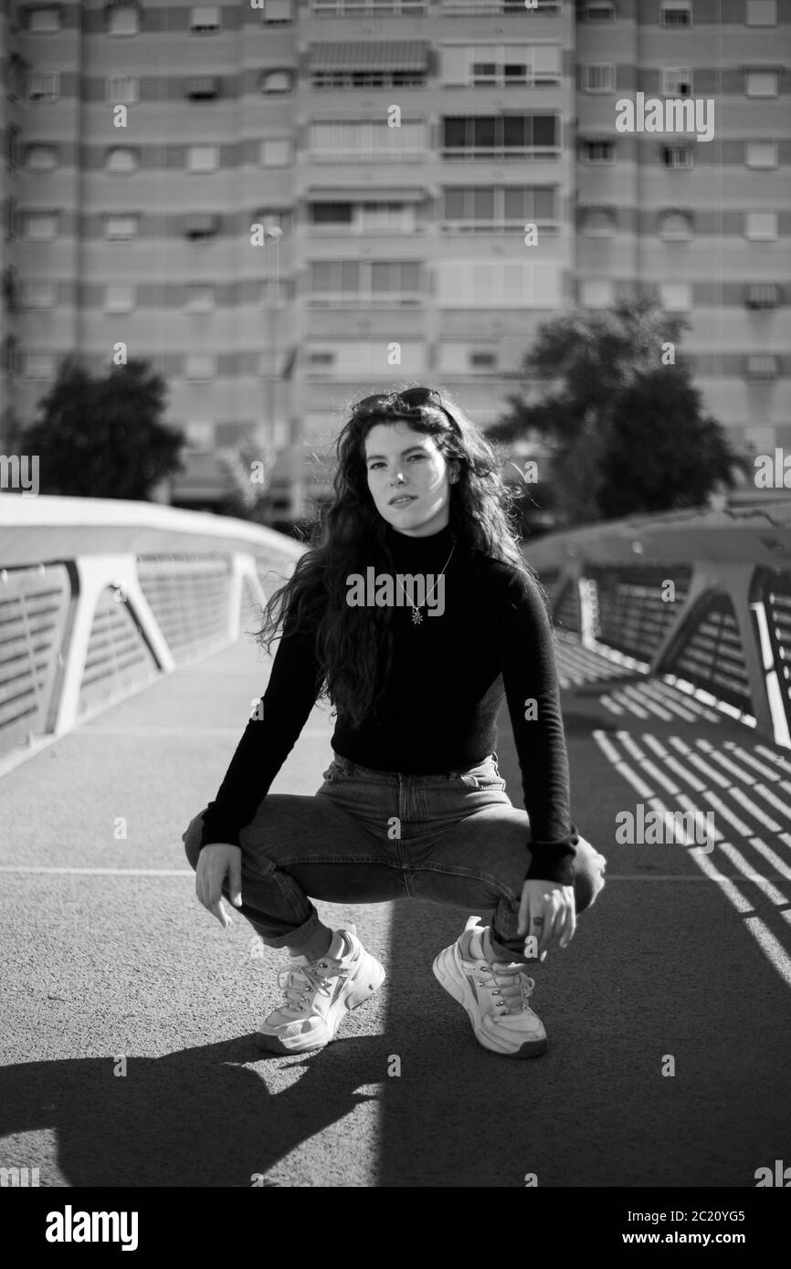 Woman portrait posing on a bridge Stock Photo - Alamy