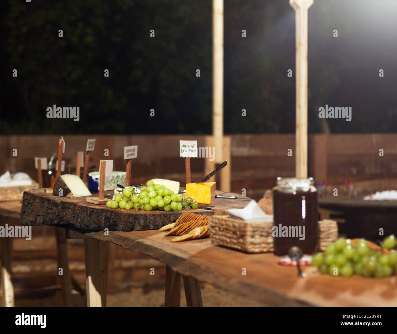 Rustic cheese board with a selection of labelled cheeses and cured ...