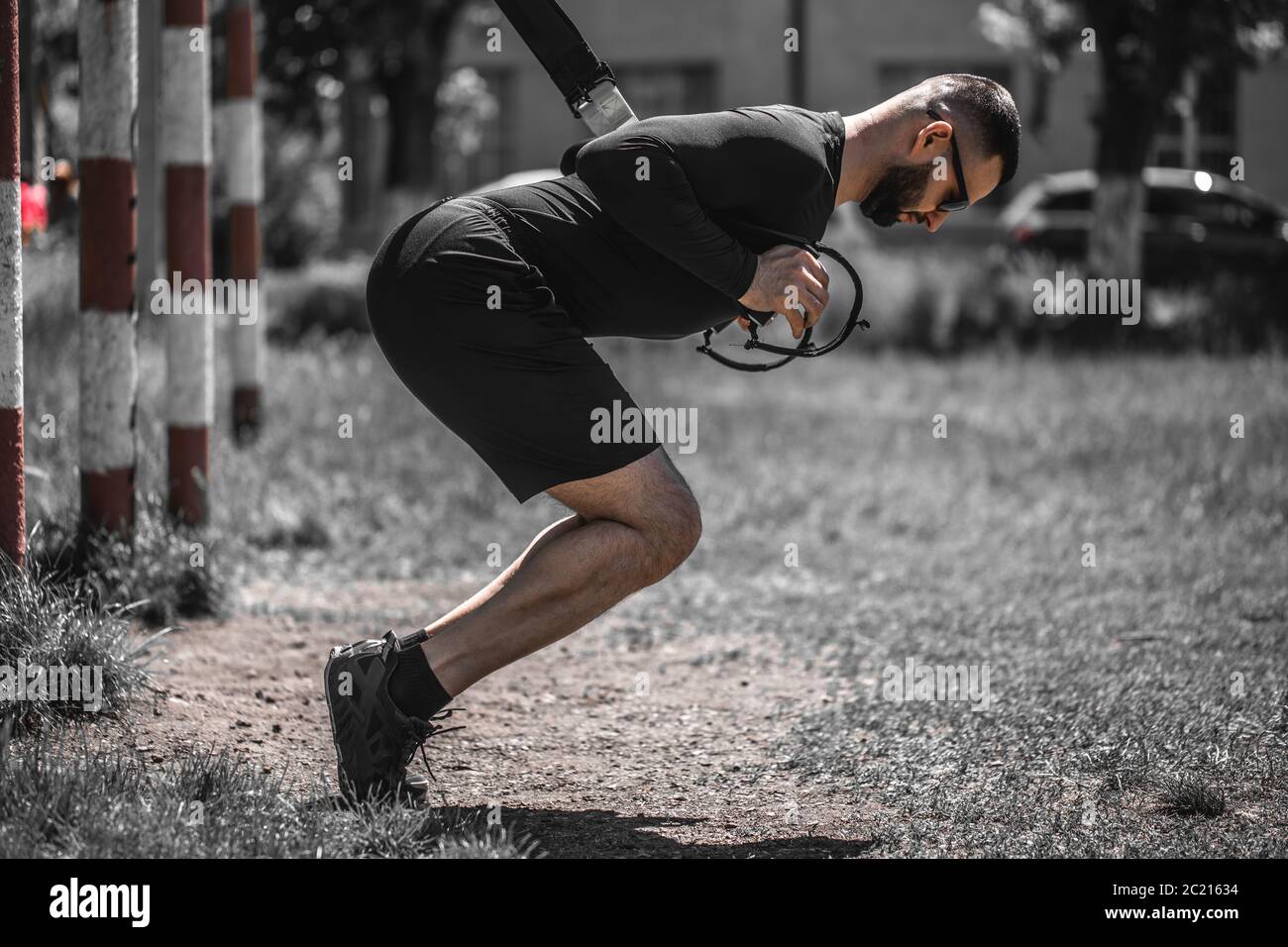 Fitness suspension straps man training with suspended lunge exercise in ...