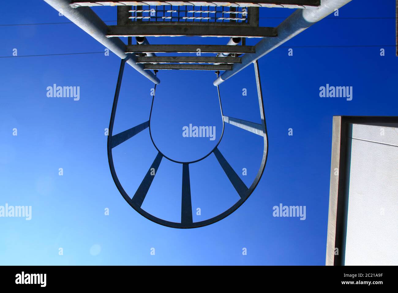 View from below of a ladder with safety bar. The look Symbolizes the ...