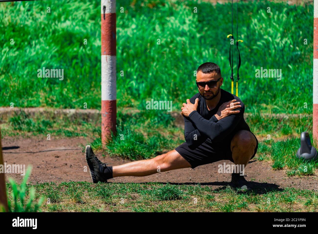Fit man stretching outside, view at sea. Fitness and sport concept. Man ...