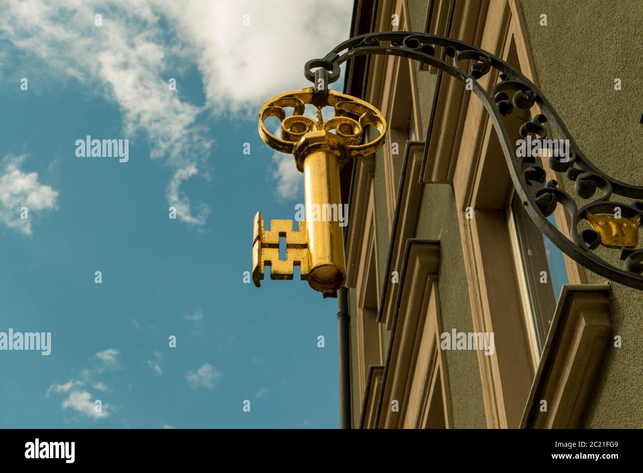 golden key on the house facade in front of a blue sky Stock Photo - Alamy