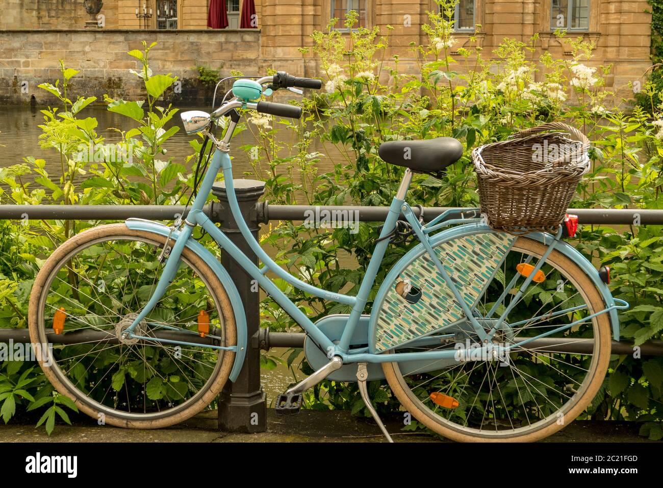 old blue bicycle with basket at the roadside Stock Photo - Alamy