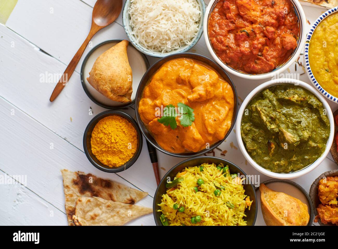 Assorted Indian various food with spices, rice and fresh vegetables ...