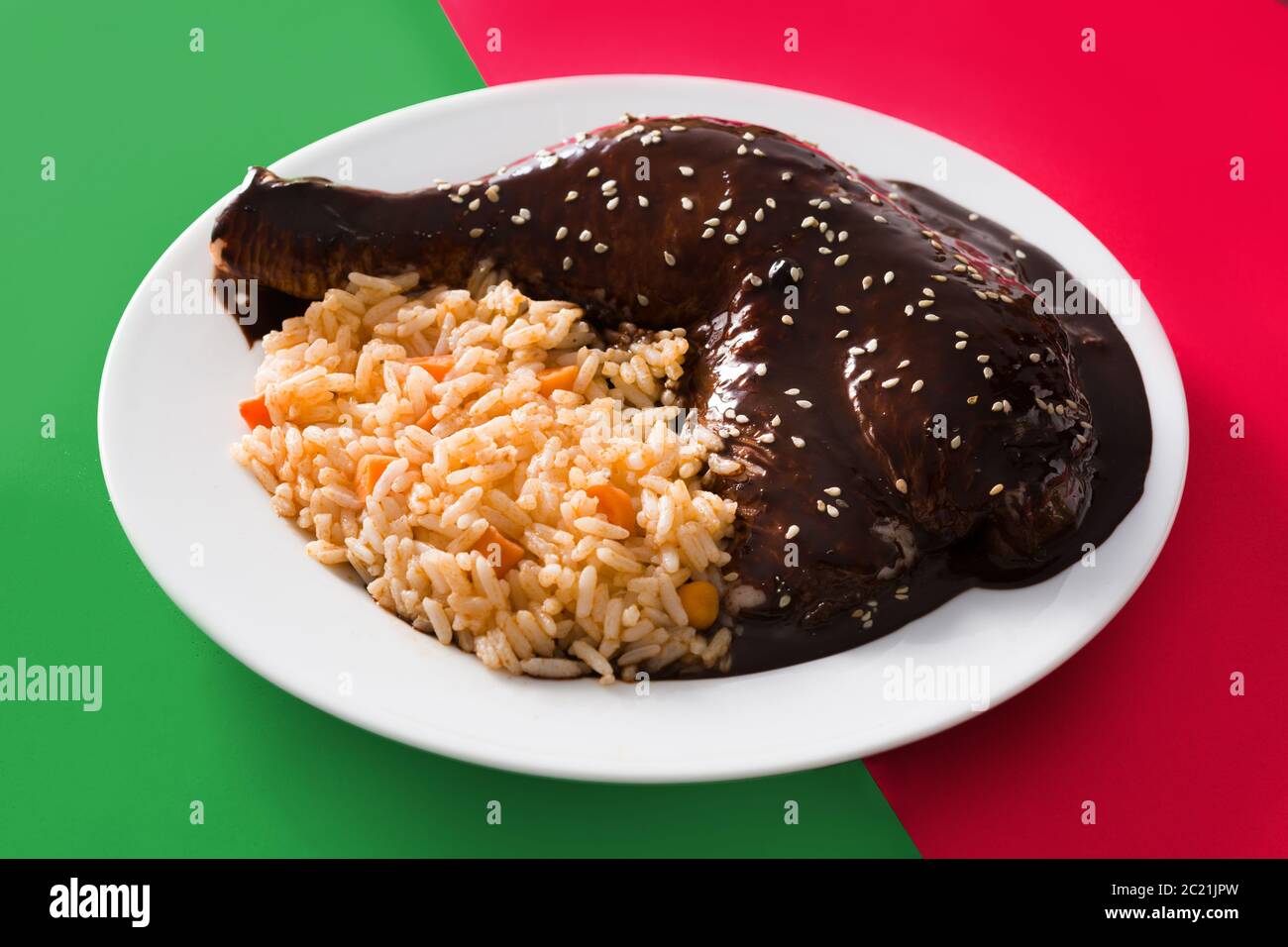 Traditional mole Poblano with rice on red and green background Stock ...