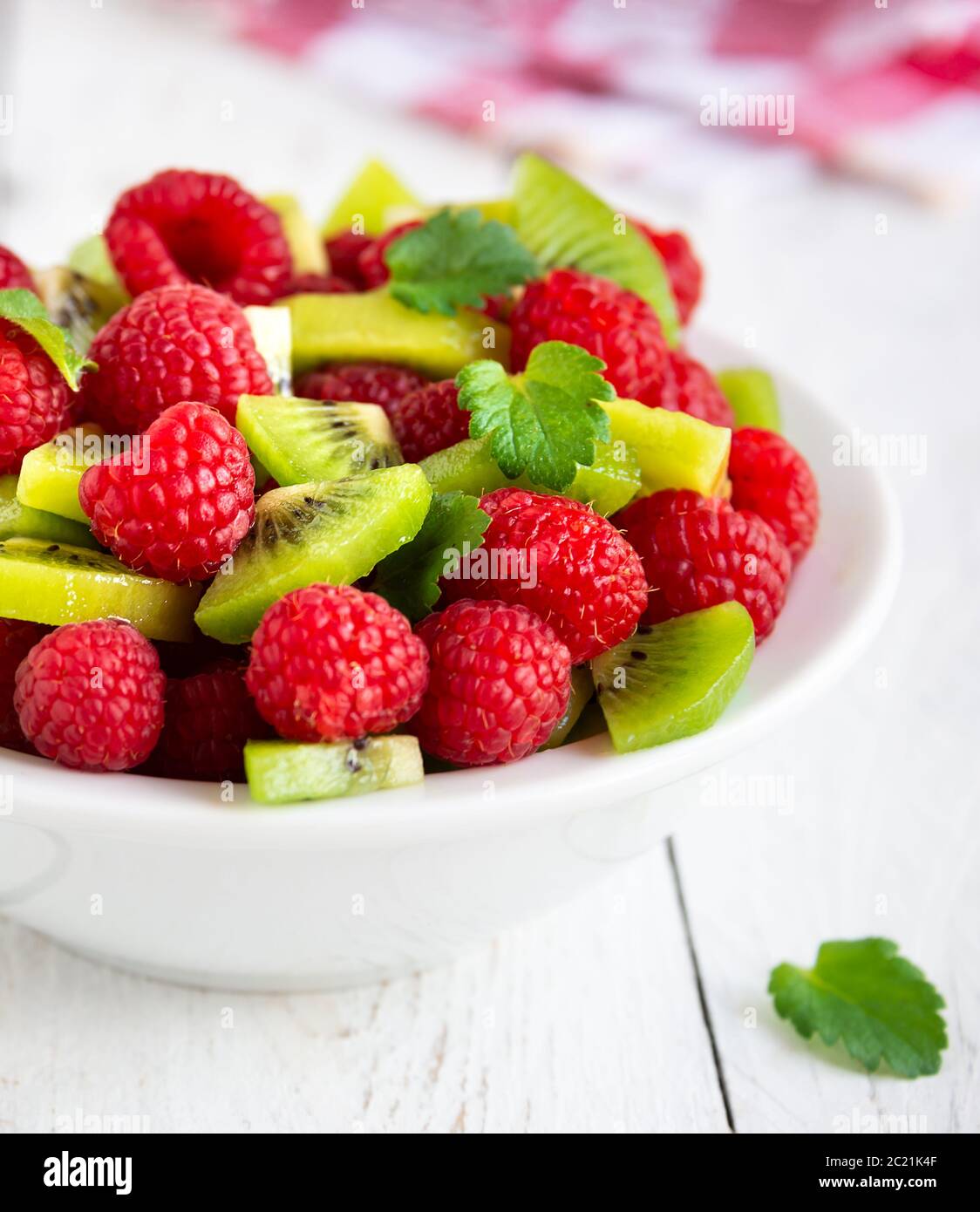 Delicious fruit salad with with raspberry and kiwi Stock Photo - Alamy