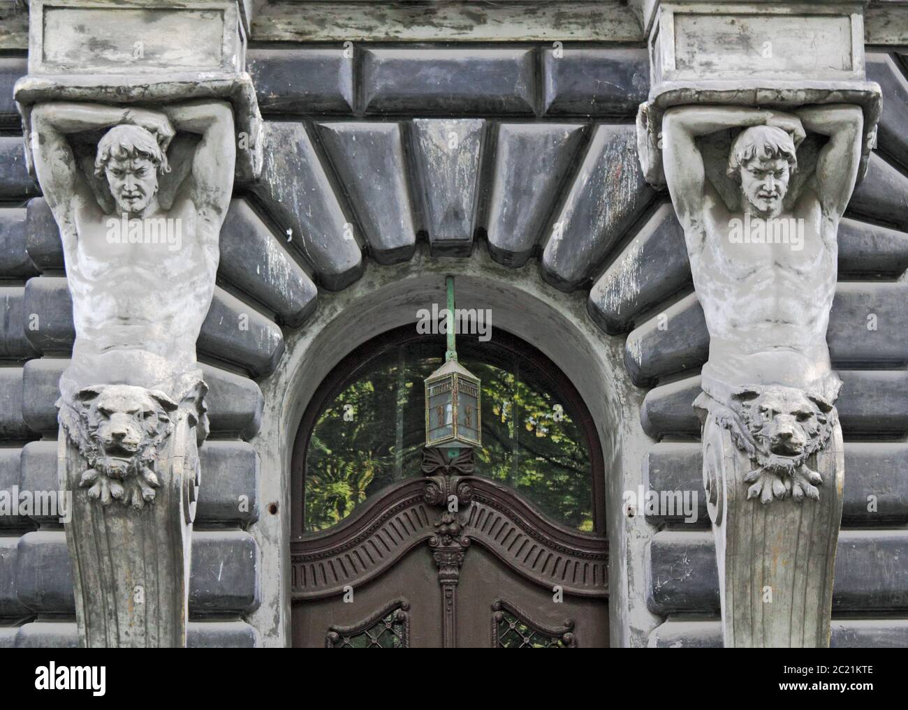Front door with statues Stock Photo - Alamy