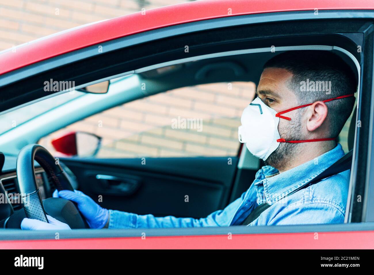 Man with mask and gloves driving a car. Concept of driving and COVID-19 ...