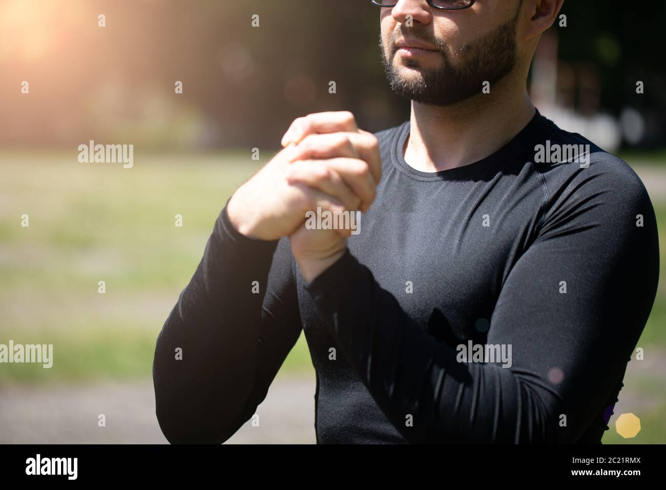 Man doing arm stretching exercises to warm up his muscles before ...