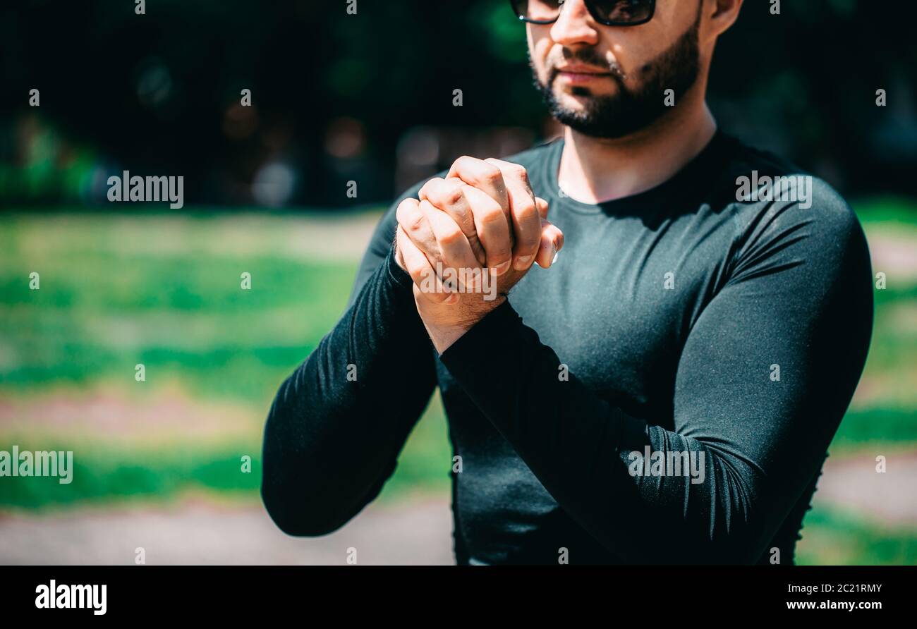 Man doing arm stretching exercises to warm up his muscles before ...