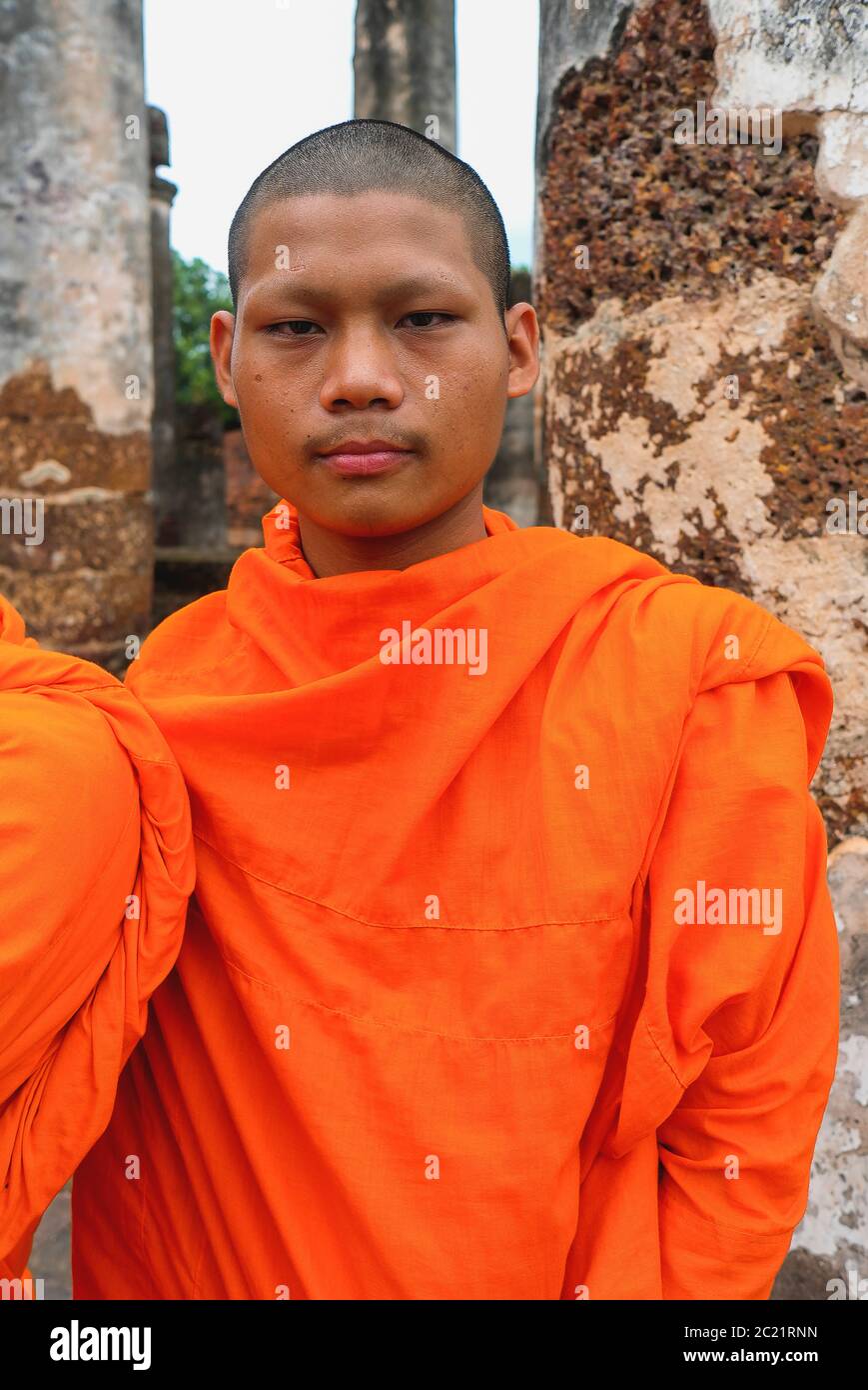 Young monks sitting by temple hi-res stock photography and images - Alamy