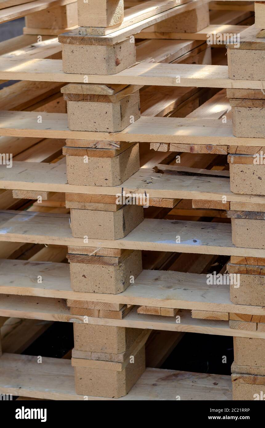 A stack of new wooden pallets. Empty pallets in a warehouse yard ...