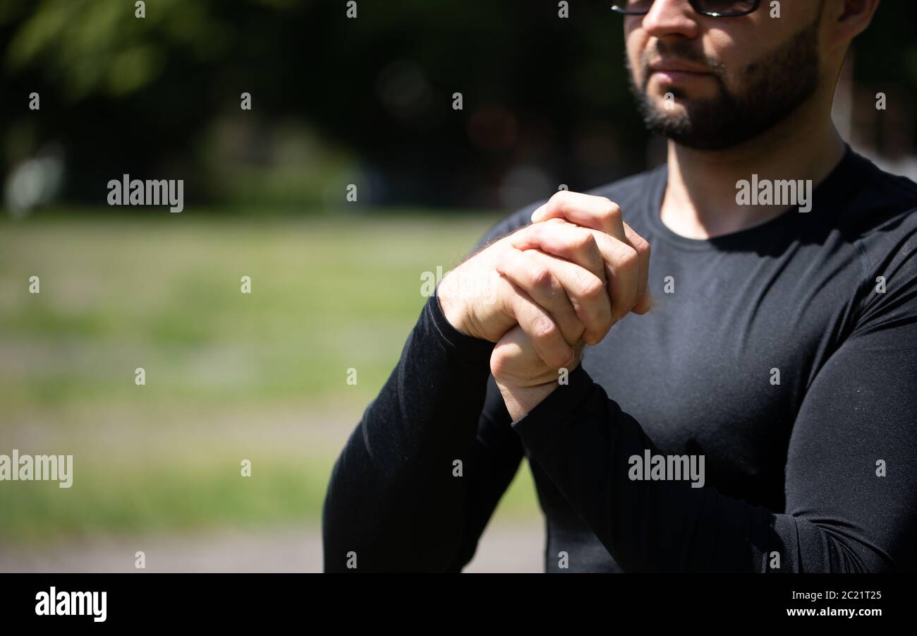 Man doing arm stretching exercises to warm up his muscles before ...