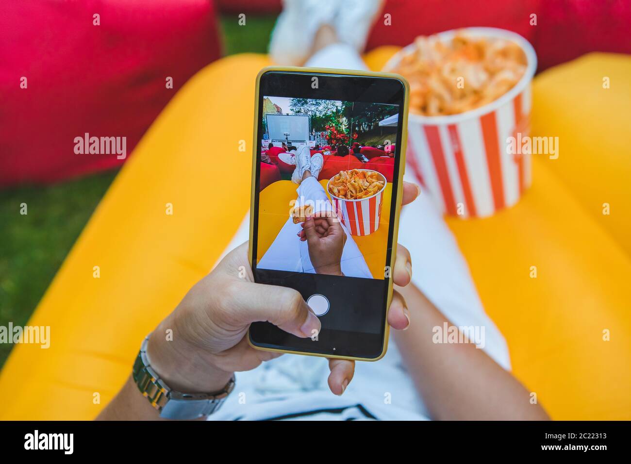woman taking picture of snacks for social networks on her phone at open ...