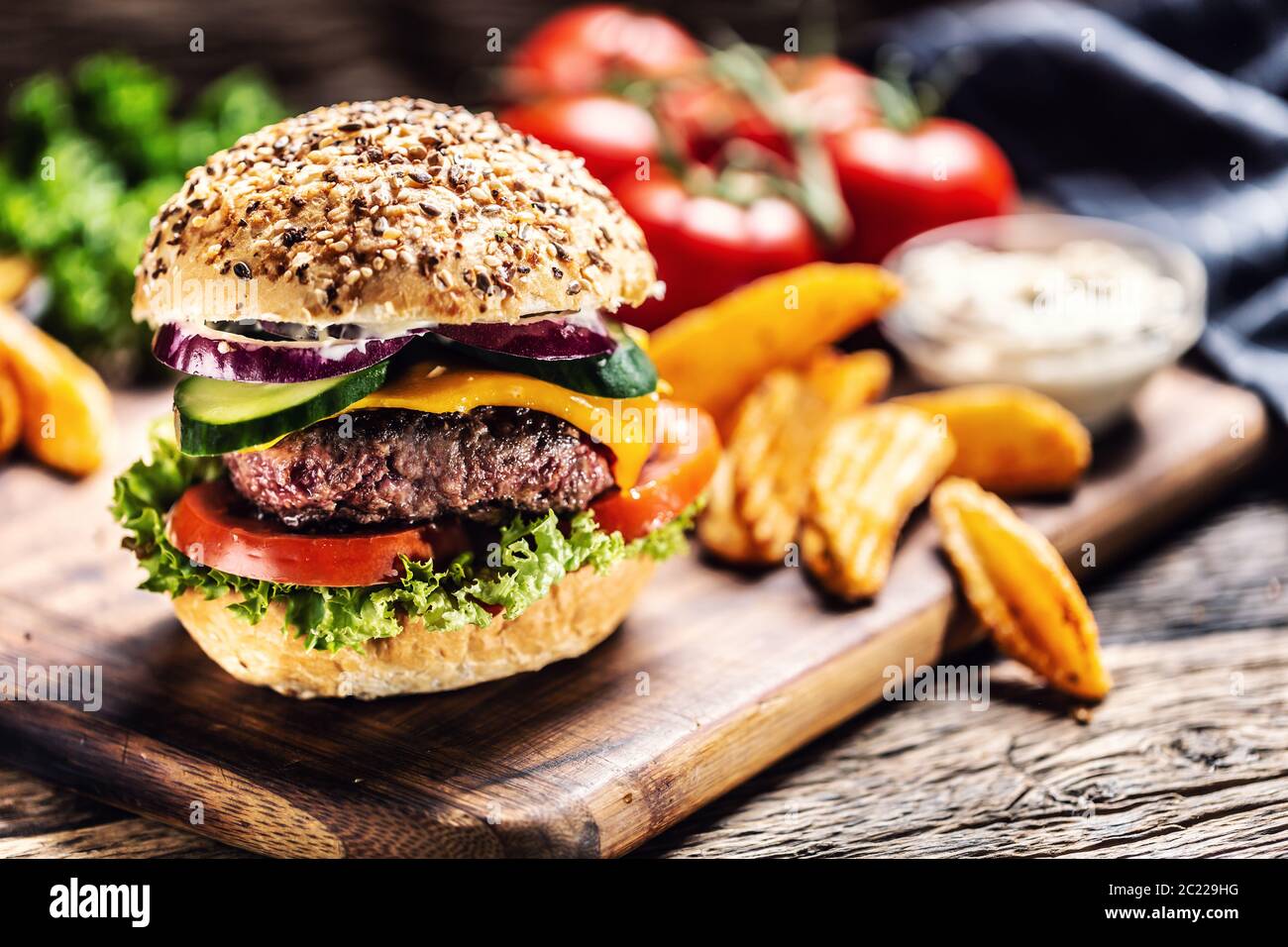 Beef burger with cucumber and onion in a sesame bun Stock Photo - Alamy