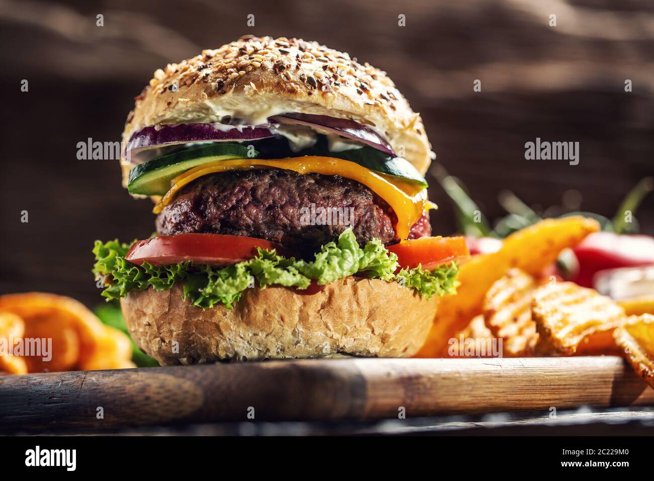 Beef burger with lettuce, tomato, mayonnaise, cheese, cucumber and ...