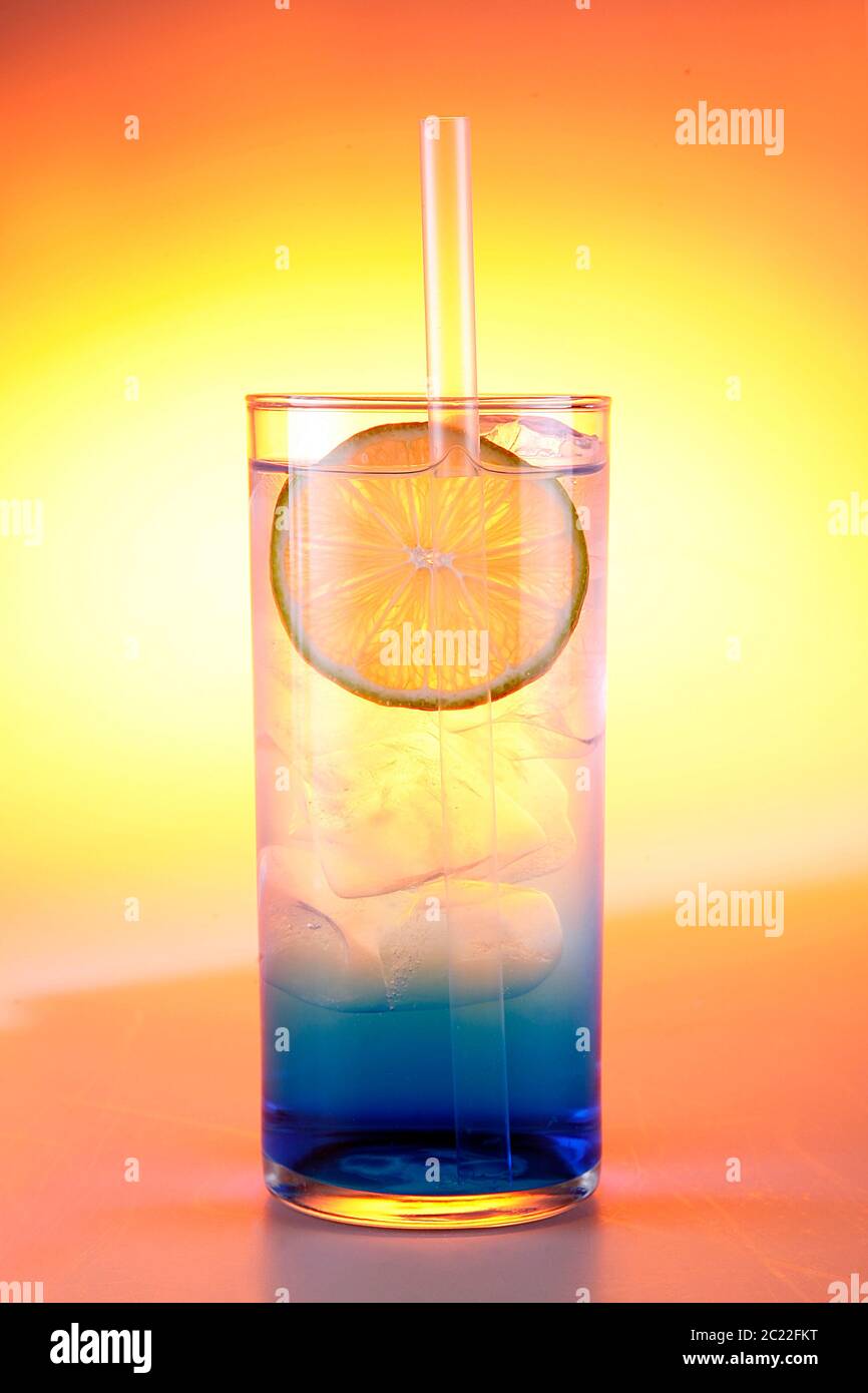 Cold fresh drink. Blue Cocktail with lemon. Jin and tonic Stock Photo ...