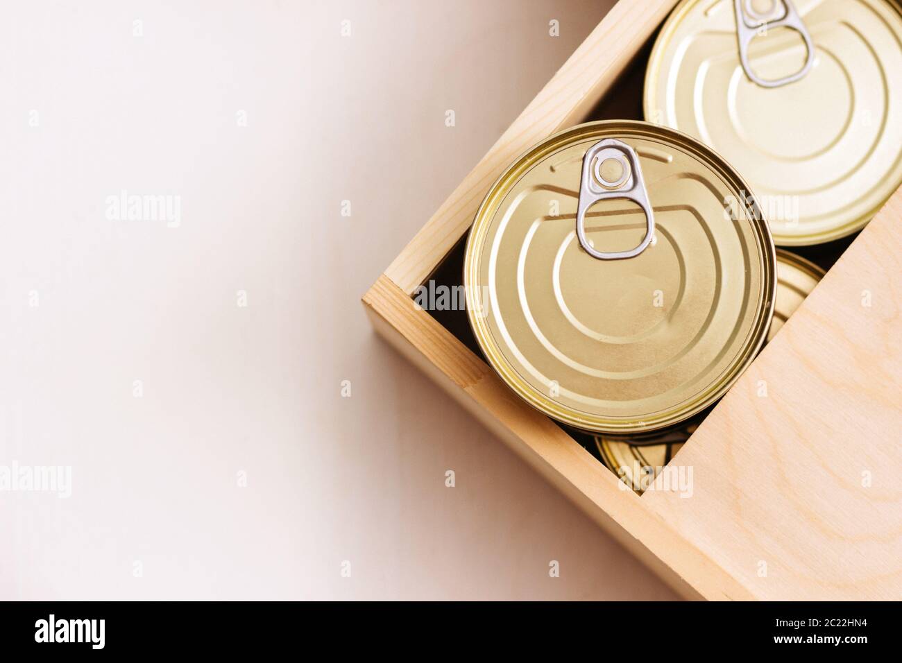 Tin cans in a box. A variety of canned food in full tin cans. Real ...