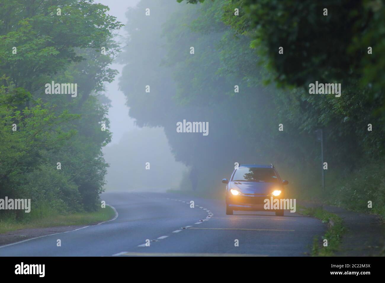 Vehicle on the road on the foggy morning in Devon Stock Photo - Alamy