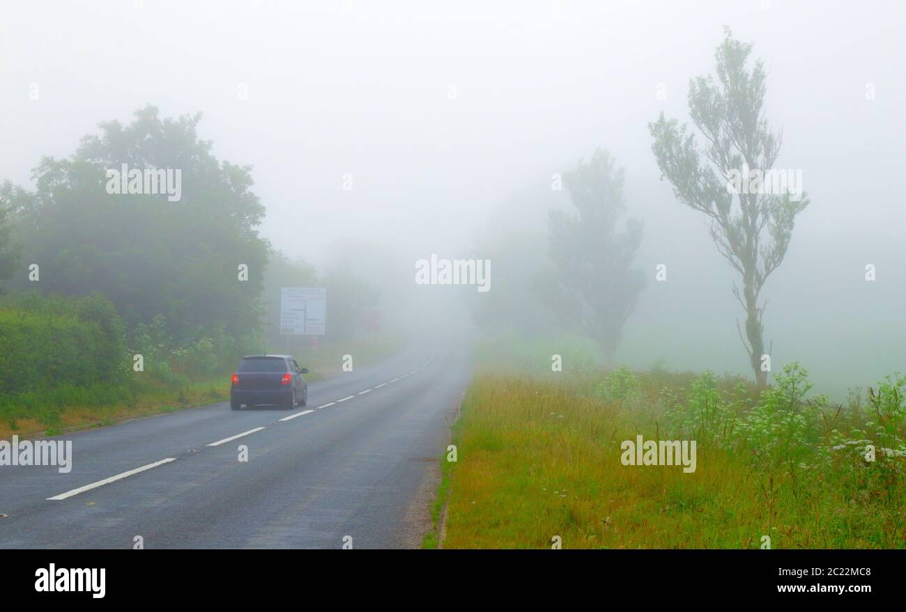 Vehicle on the road on the foggy morning in Devon Stock Photo - Alamy