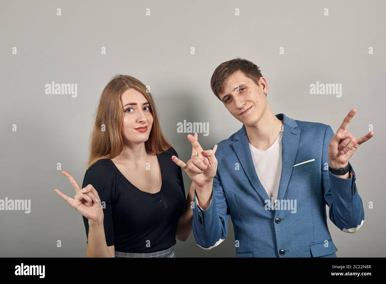 Giving rock and roll sign, showing symbol of horns, language gestures ...