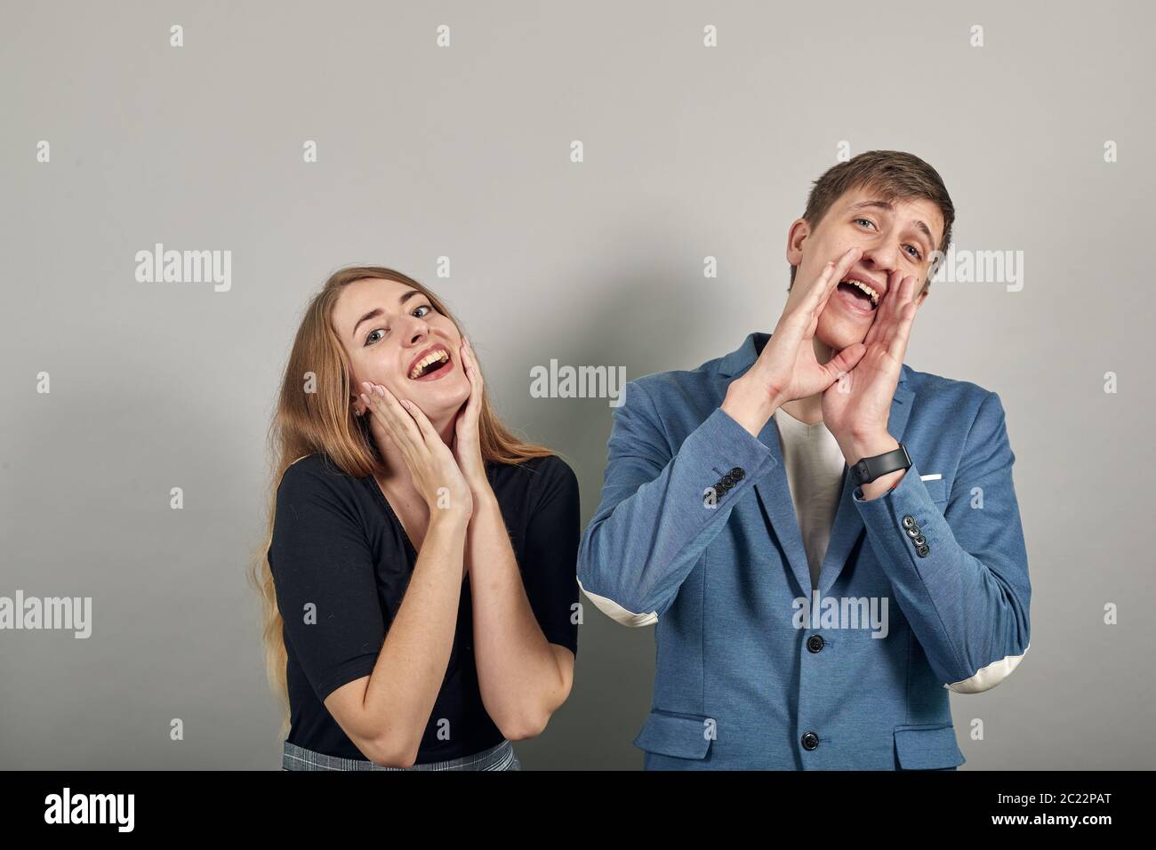 Scream and shout holding hands near opened mouth. Screaming loudly with ...