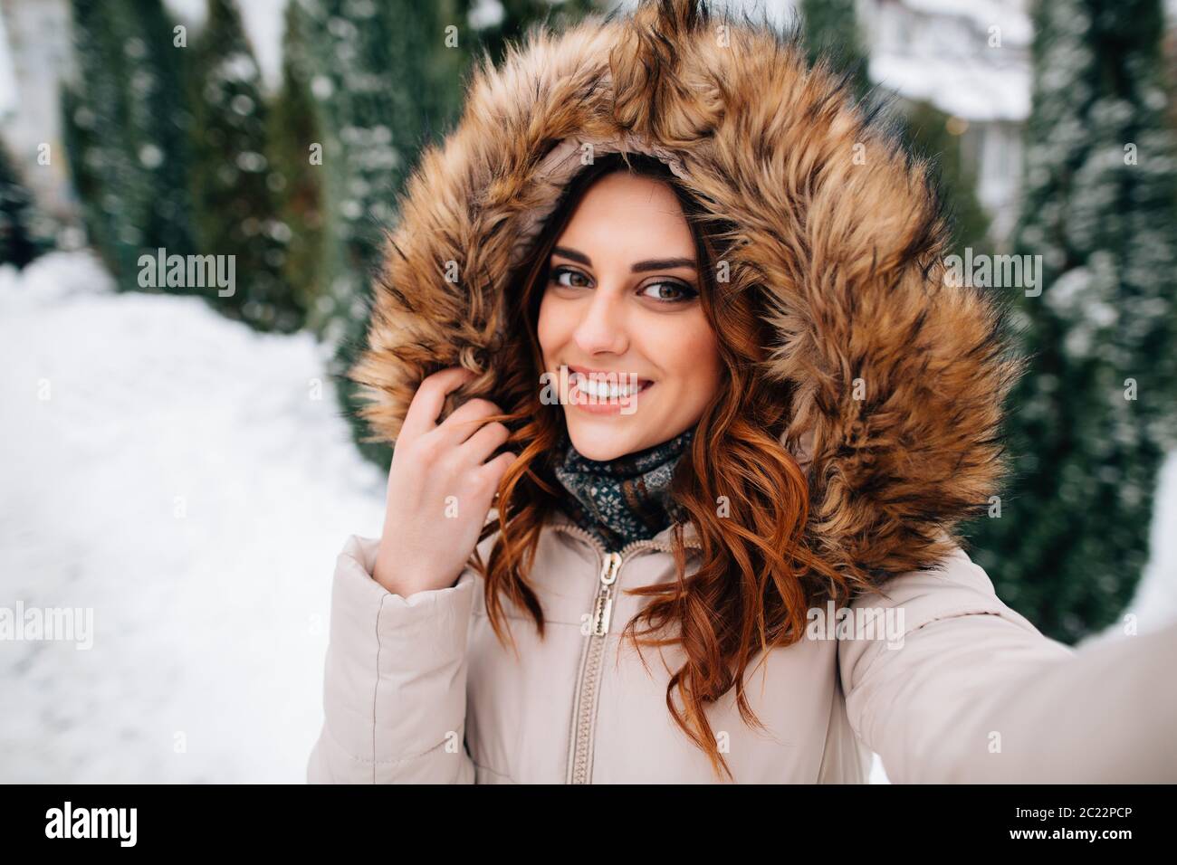 Winter Selfie Beautiful Girl In Fur Hood Takes Selfie In Snowy Winter