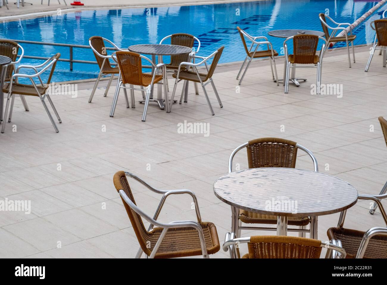 Metal tables and chairs with wicker seats in an outdoor cafe Stock ...