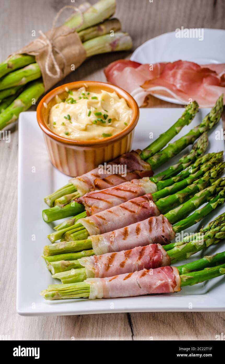 Asparagus on grill with bacon and home mayonnaise Stock Photo - Alamy