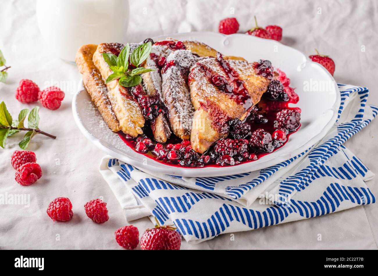 French toast with fruits and forest fruit reduction Stock Photo - Alamy