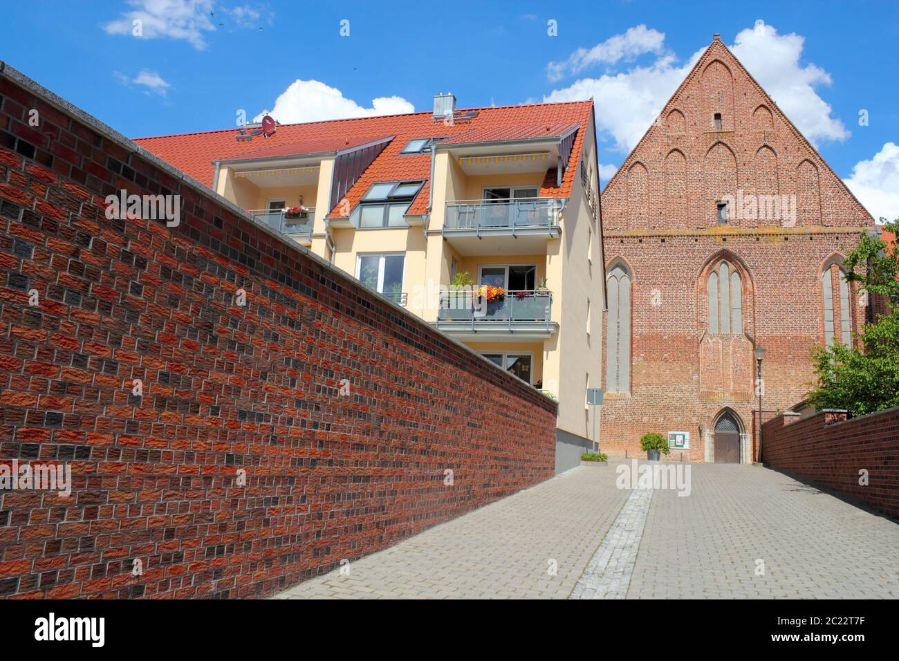 Wall, new building and church Stock Photo - Alamy