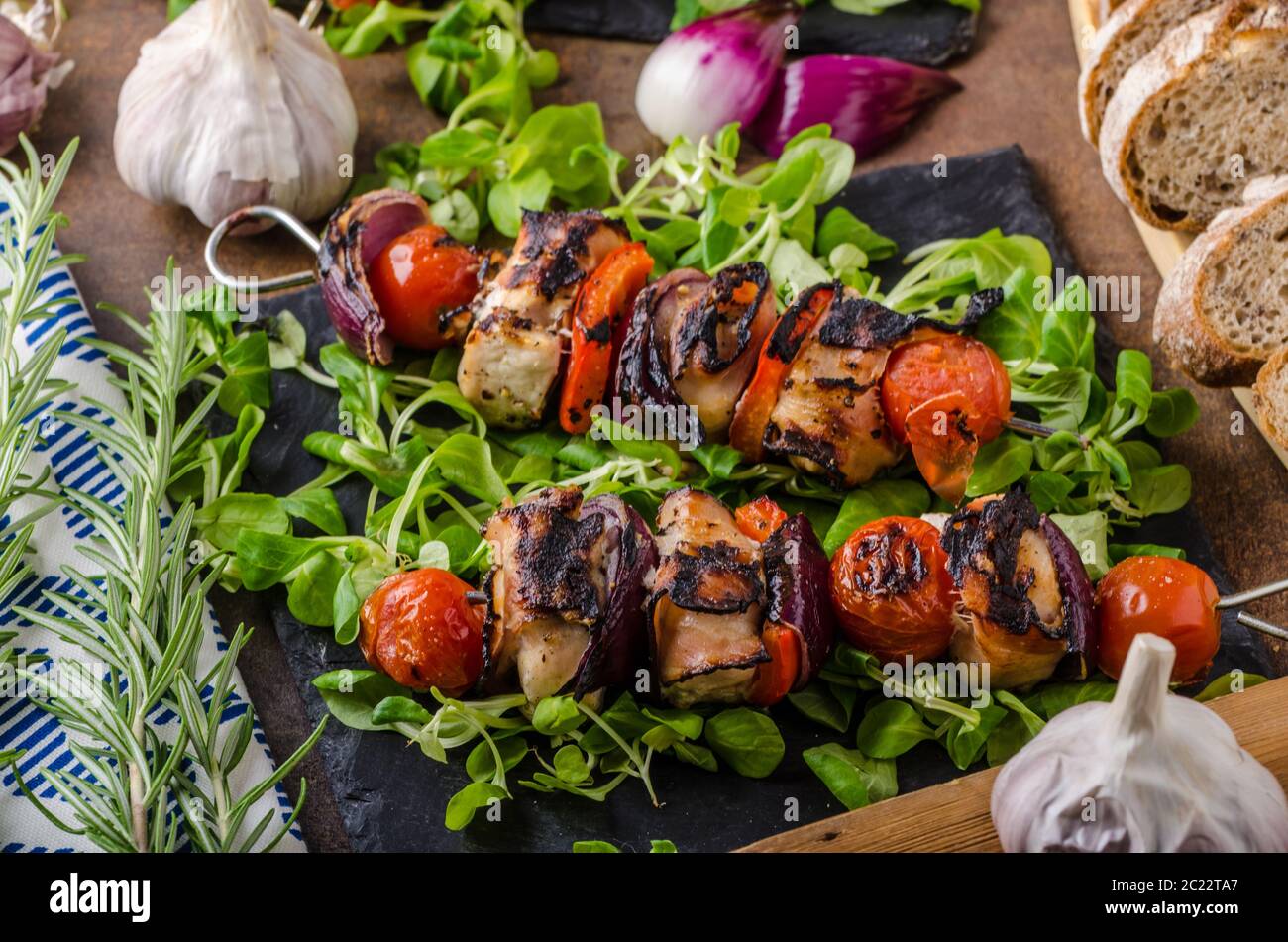 Grilled meat skewer with bacon and crunchy vegetables Stock Photo - Alamy