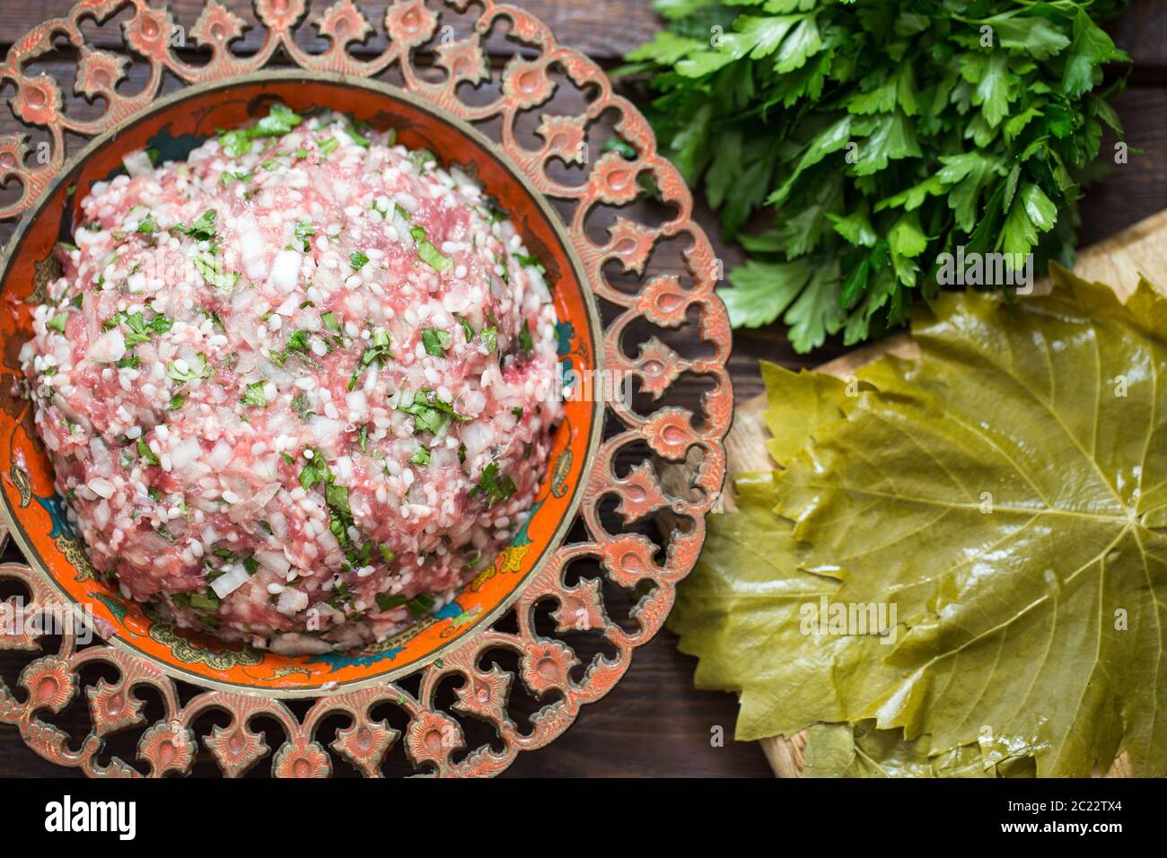 preparing stuffed vine leaves with rice and meat, or traditional Dolma ...