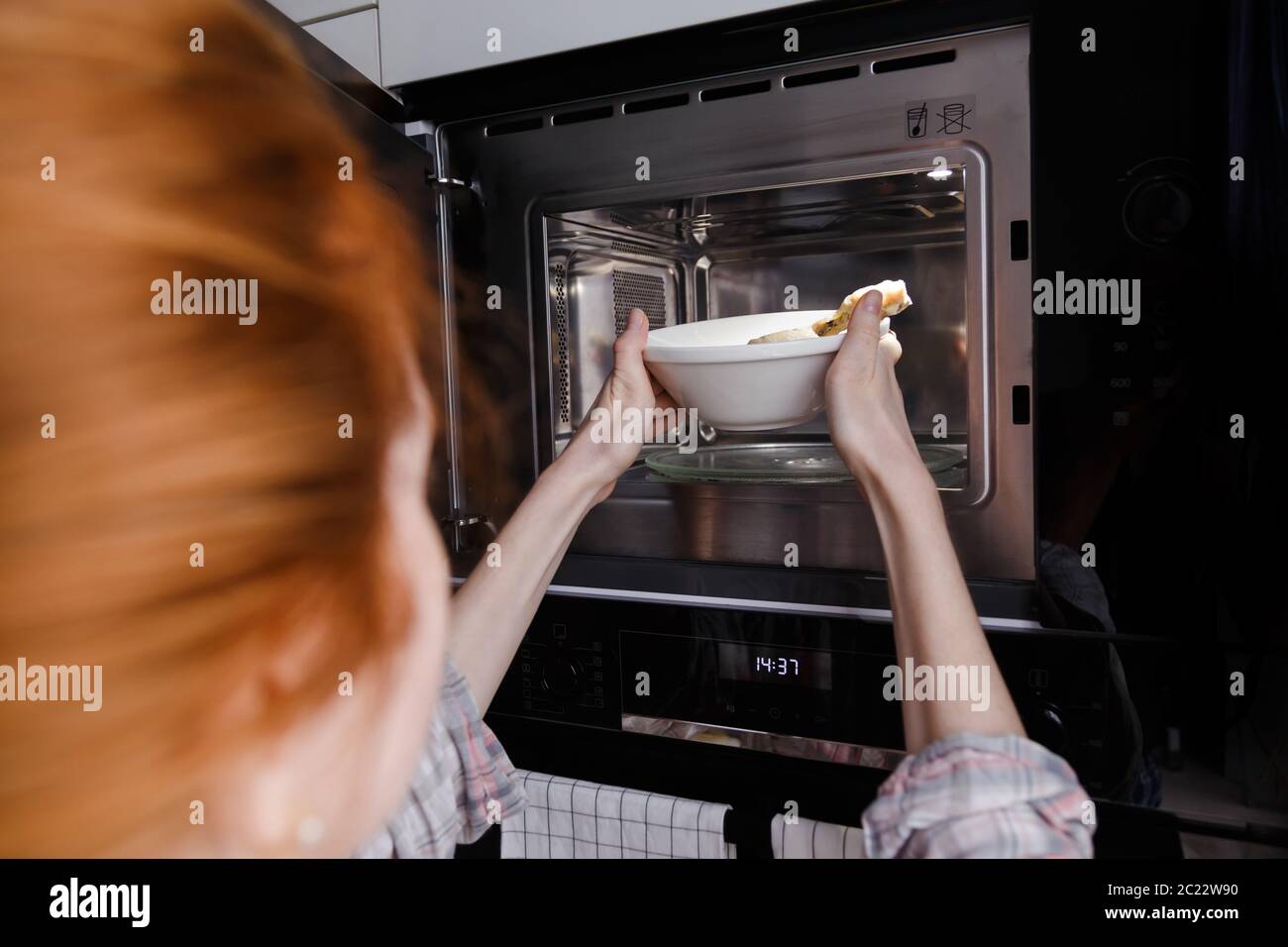 Woman cooking microwave in hi-res stock photography and images - Alamy