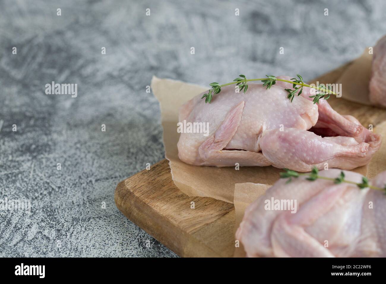 Raw uncooked quail. raw meat quails ready for cooking on a cutting ...