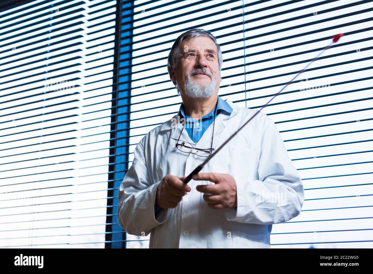 Senior chemistry professor giving a lecture in front of classroom full ...