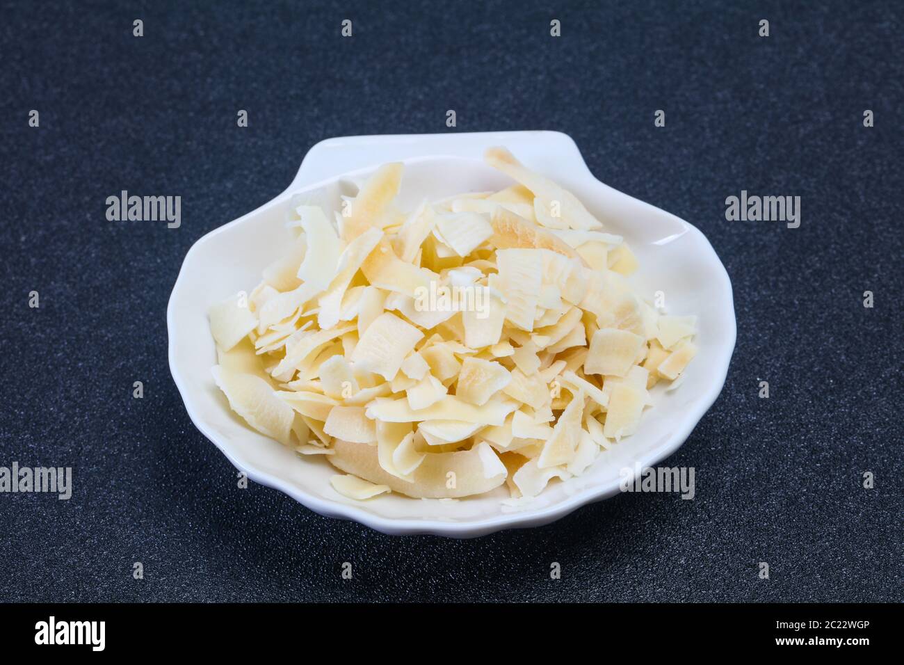 Coconut dry chips snack in the bowl Stock Photo - Alamy