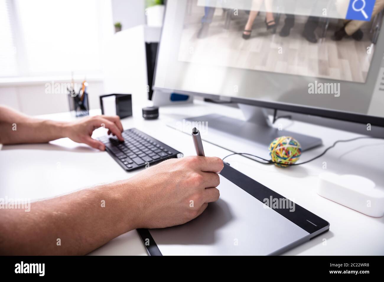 Designer Working On Digital Tablet Using Stylus Pen On White Desk At ...